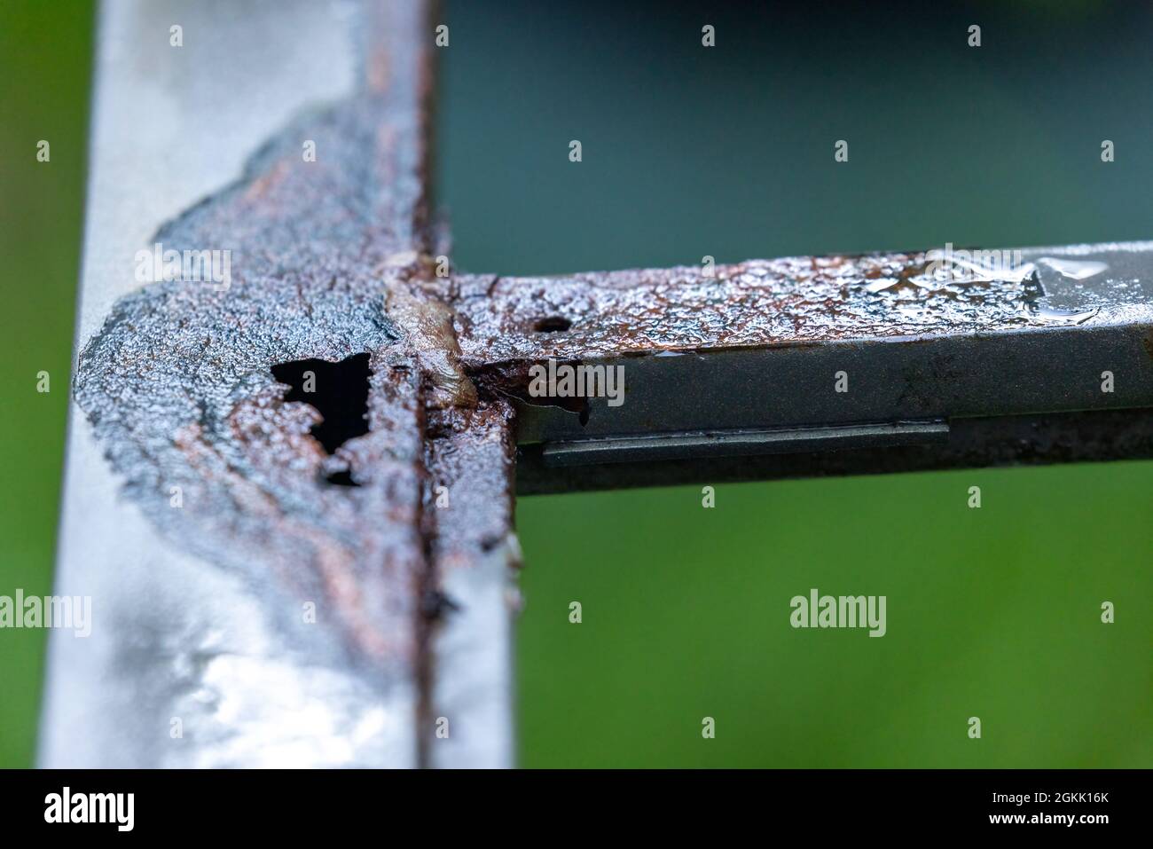 corroded rusty holes in a metal frame where water collected Stock Photo ...
