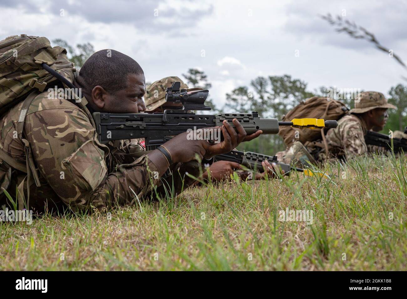 Soldiers with the Royal Bermuda Regiment simulate a maneuver under fire ...