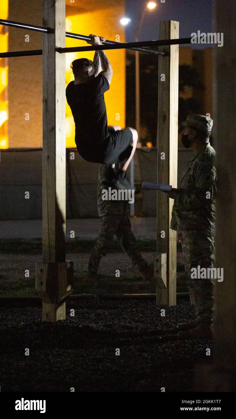 U.S. Army Staff Sgt. Vicente Limon executes a leg tuck during the Army ...