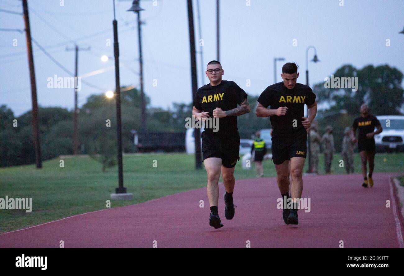 U.S. Army Sgt. Tanner Kao, left, runs alongside another U.S. Army ...