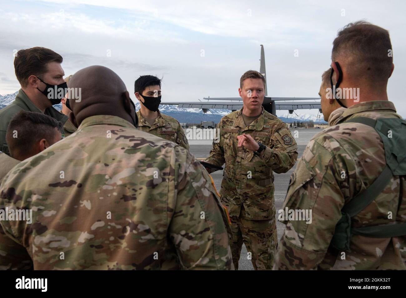 Air Force Maj. Mark Kellar, 3rd right, a C-130J Super Hercules pilot ...