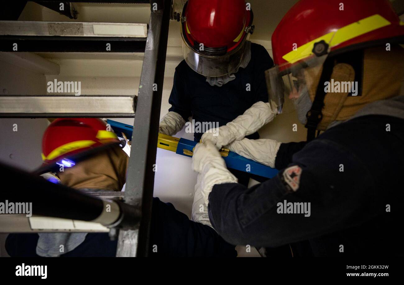 210511-N-QI061-0075 ATLANTIC OCEAN (May 11, 2021) Sailors extend a ...