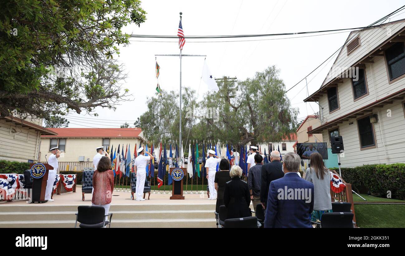 The official party salutes the flag during morning colors at the Naval ...