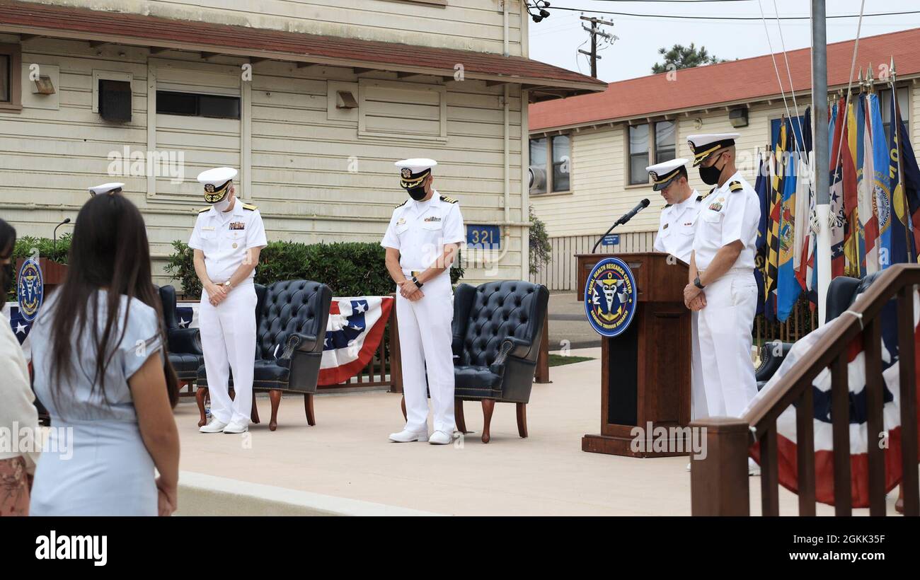 The official party bow their heads during the benediction at the Naval ...
