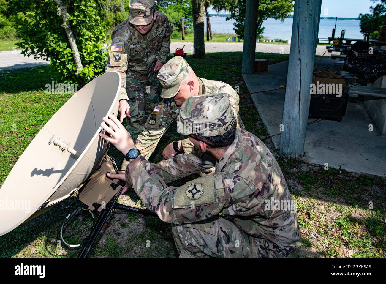 Army Chief Warrant Officer 2 Kyle Stryker (left) advises his team on ...