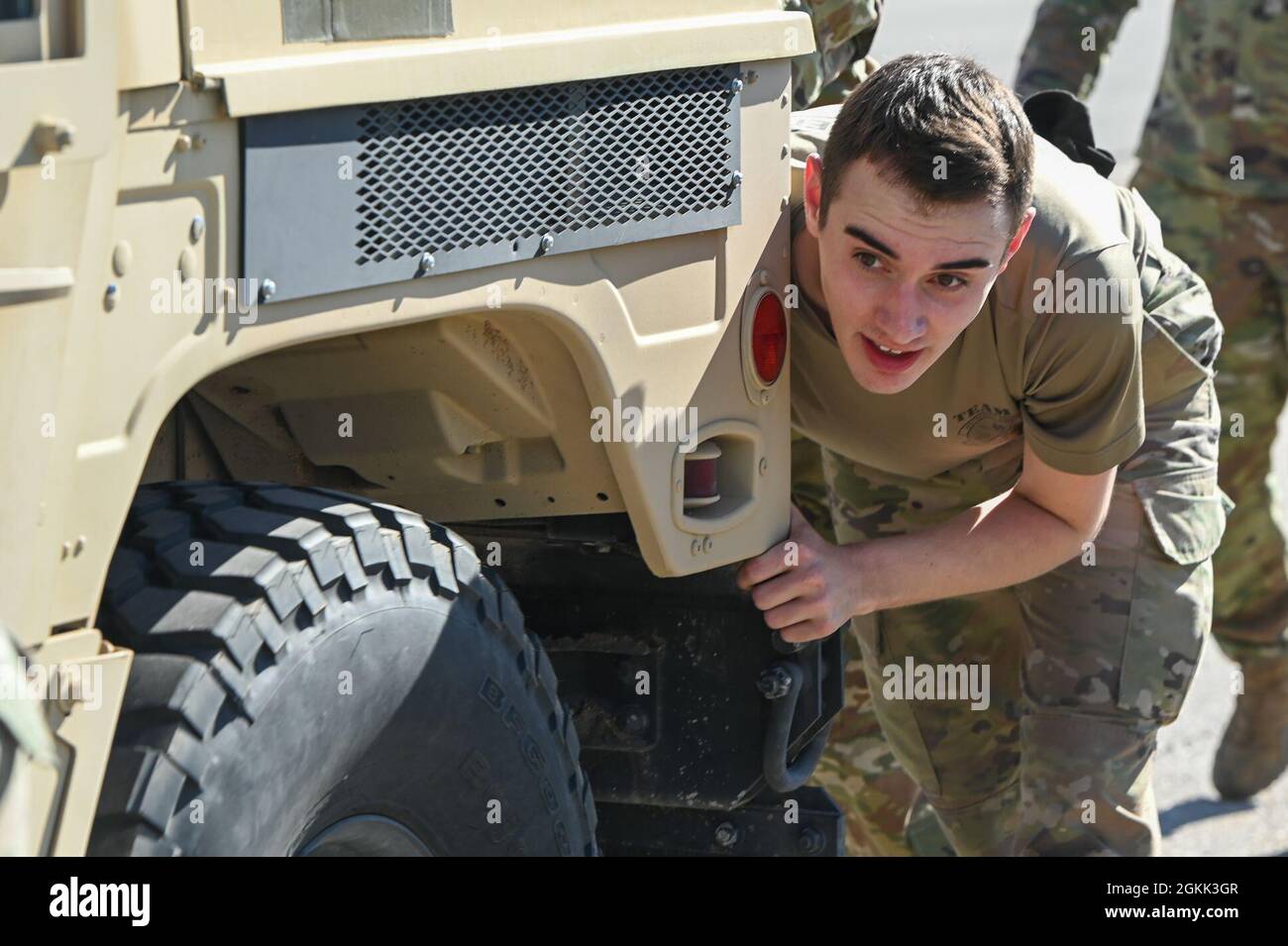 Airman 1st Class Justin Dunlevy, 75th Security Forces Squadron, helps ...