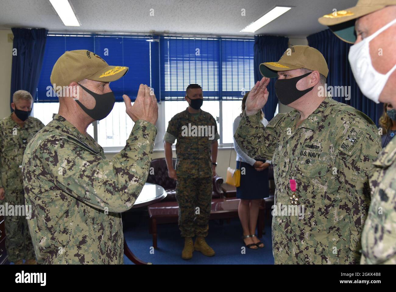 OKINAWA, Japan (May 12, 2021) Rear Adm. Fred Kacher, salutes, Vice Adm ...