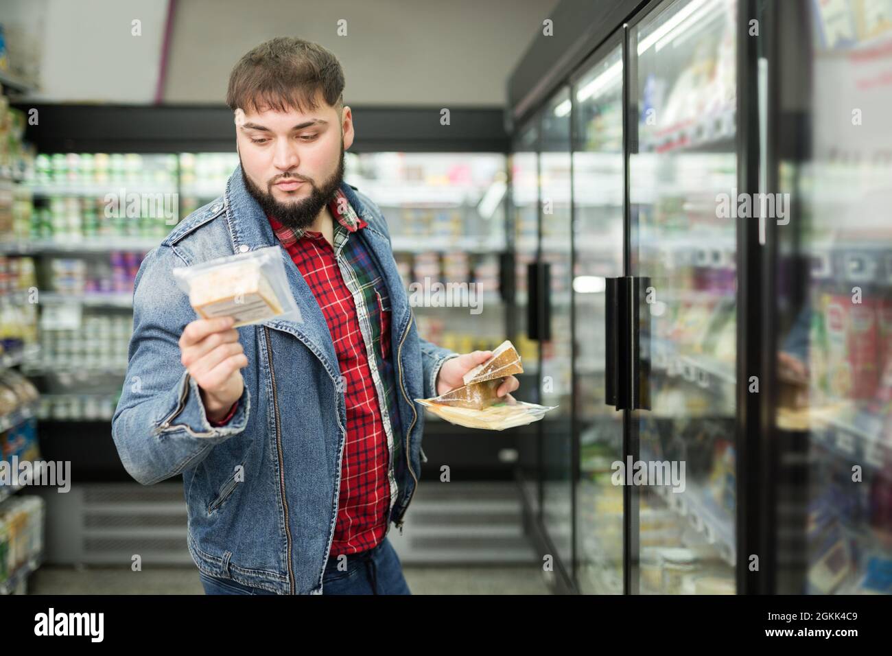 man shopping in grocery store, looking for hard cheese Stock Photo - Alamy