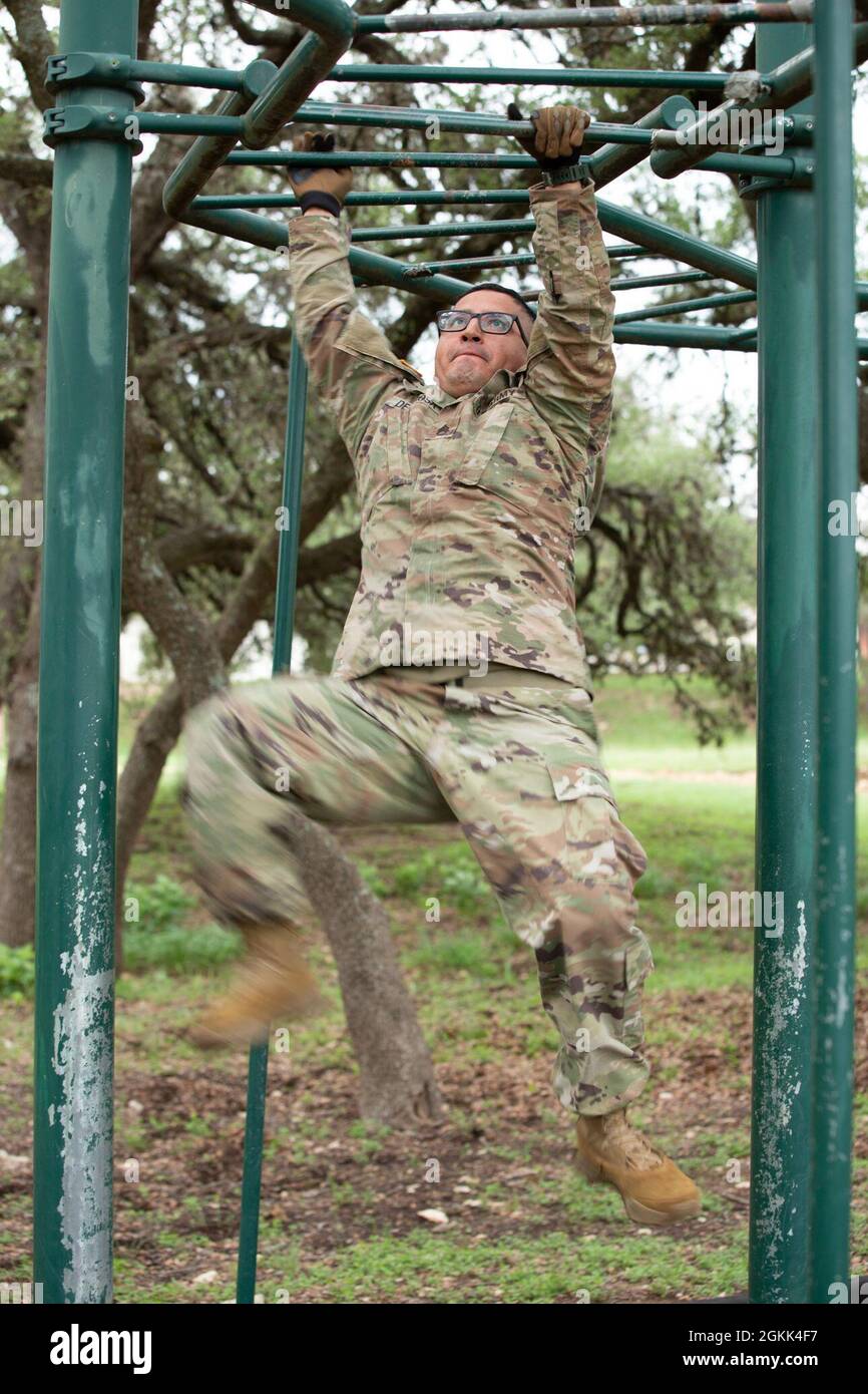 .S. Army Staff Sgt. Angel Delarosa successfully crosses the horizontal ...