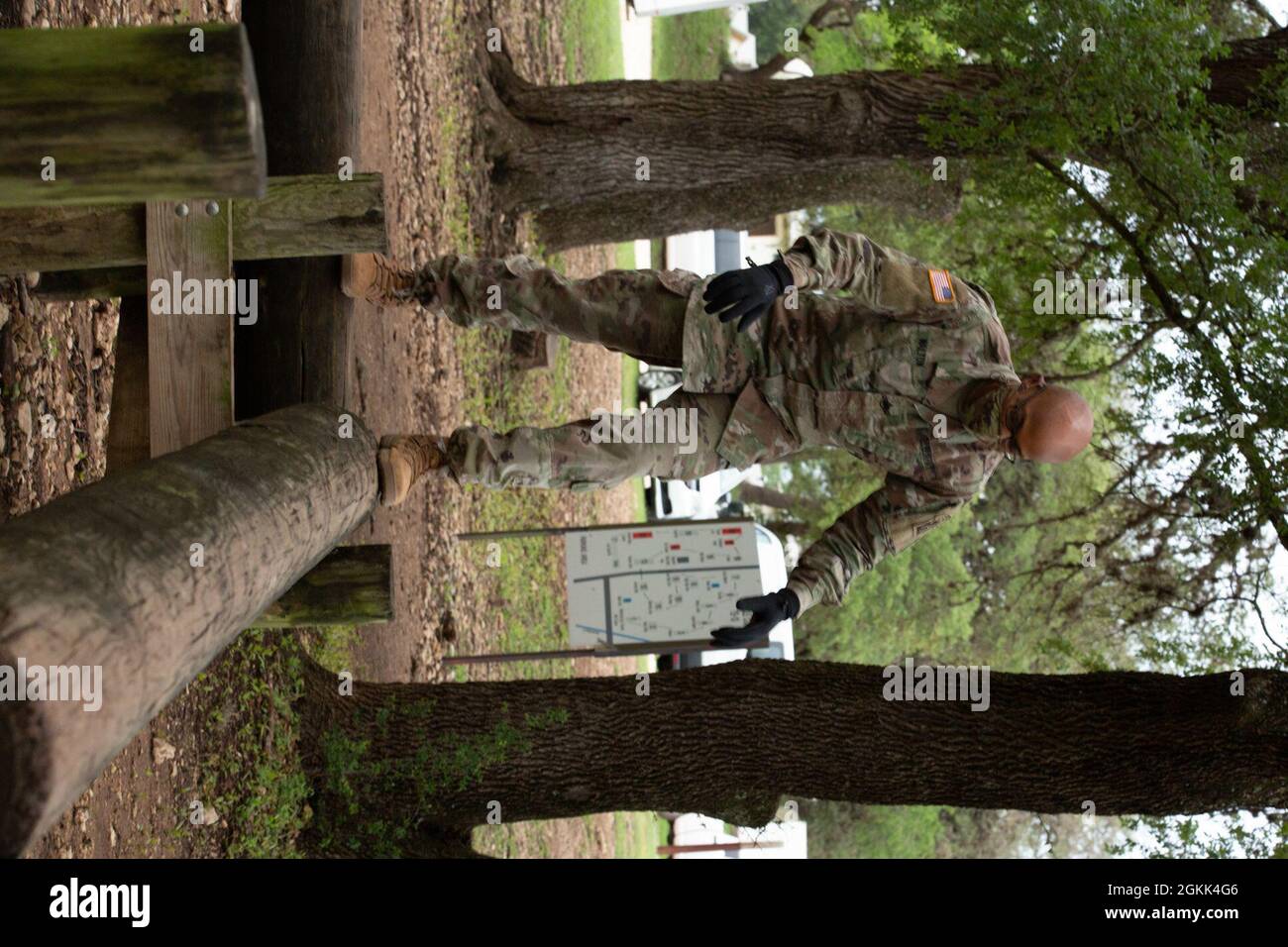 U.S. Army Staff Sgt. Corey Walton walks across a beam while competing ...