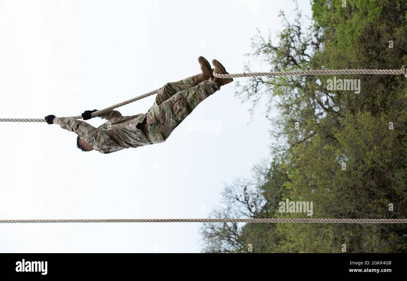 A U.S. Army Soldier successfully climbs a rope while competing in an ...