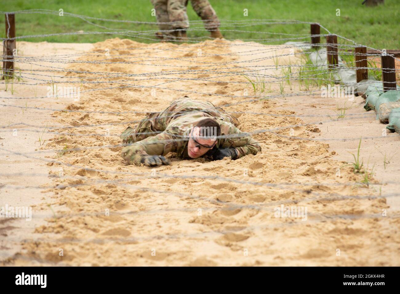 U.S. Army Spc. Mitchell Robinson low crawls under barbed wire while ...