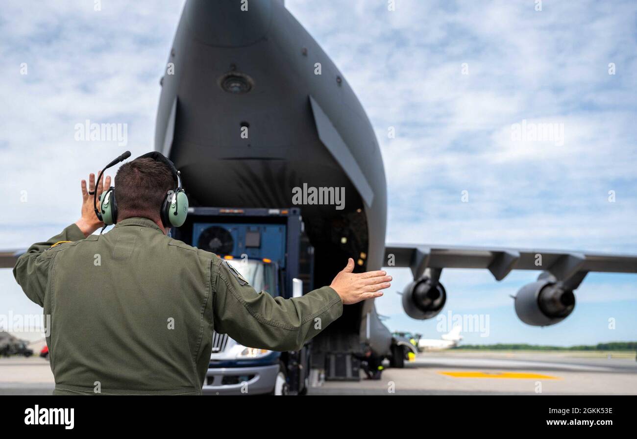 Tech. Sgt. Justin Peters, 156th Airlift Squadron loadmaster, marshals a ...