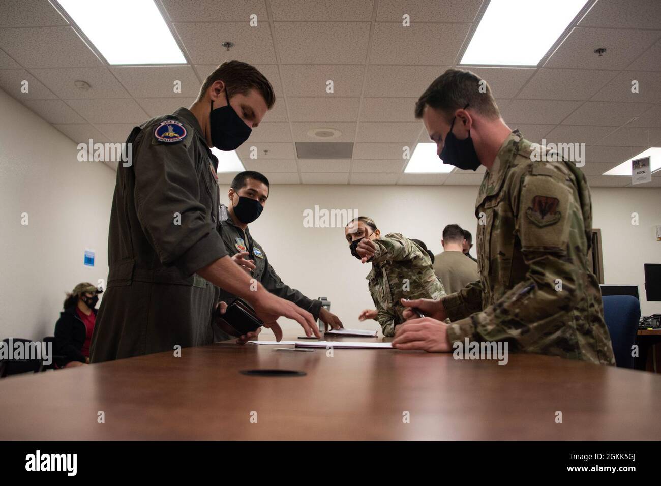 Airmen process through the personnel deployment function line at Davis ...