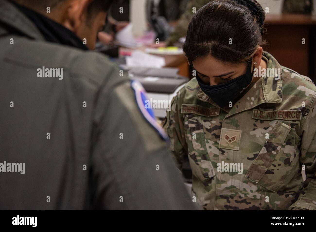 Airmen process through the personnel deployment function line at Davis ...