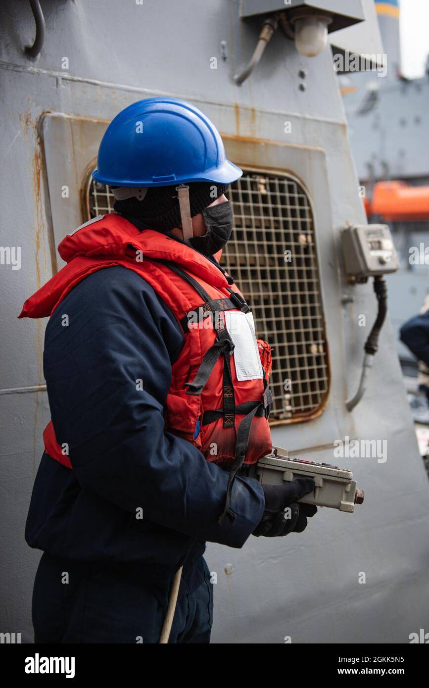 U.S. Navy Seaman Dominic Hollman, from Effort, Penn., controls a ...