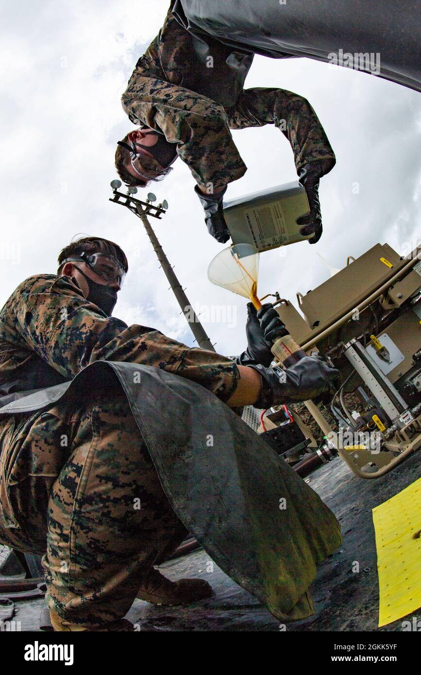 U.S. Marines with 31st Marine Expeditionary Unit (MEU) pour corrosion ...