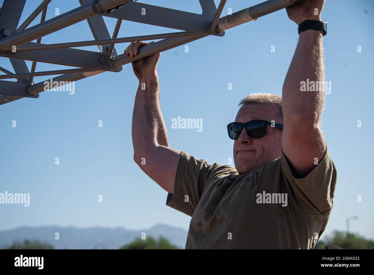 An Airman performs a pull-up during the 355th Security Forces Squadron ...