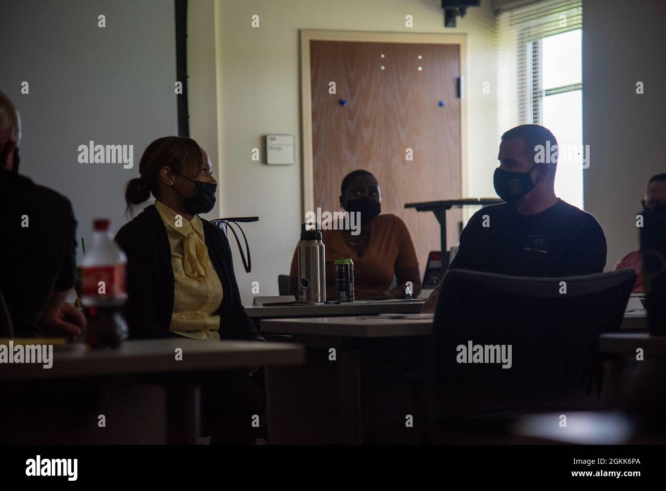 Two service members discuss a suicide intervention scenario during an ...