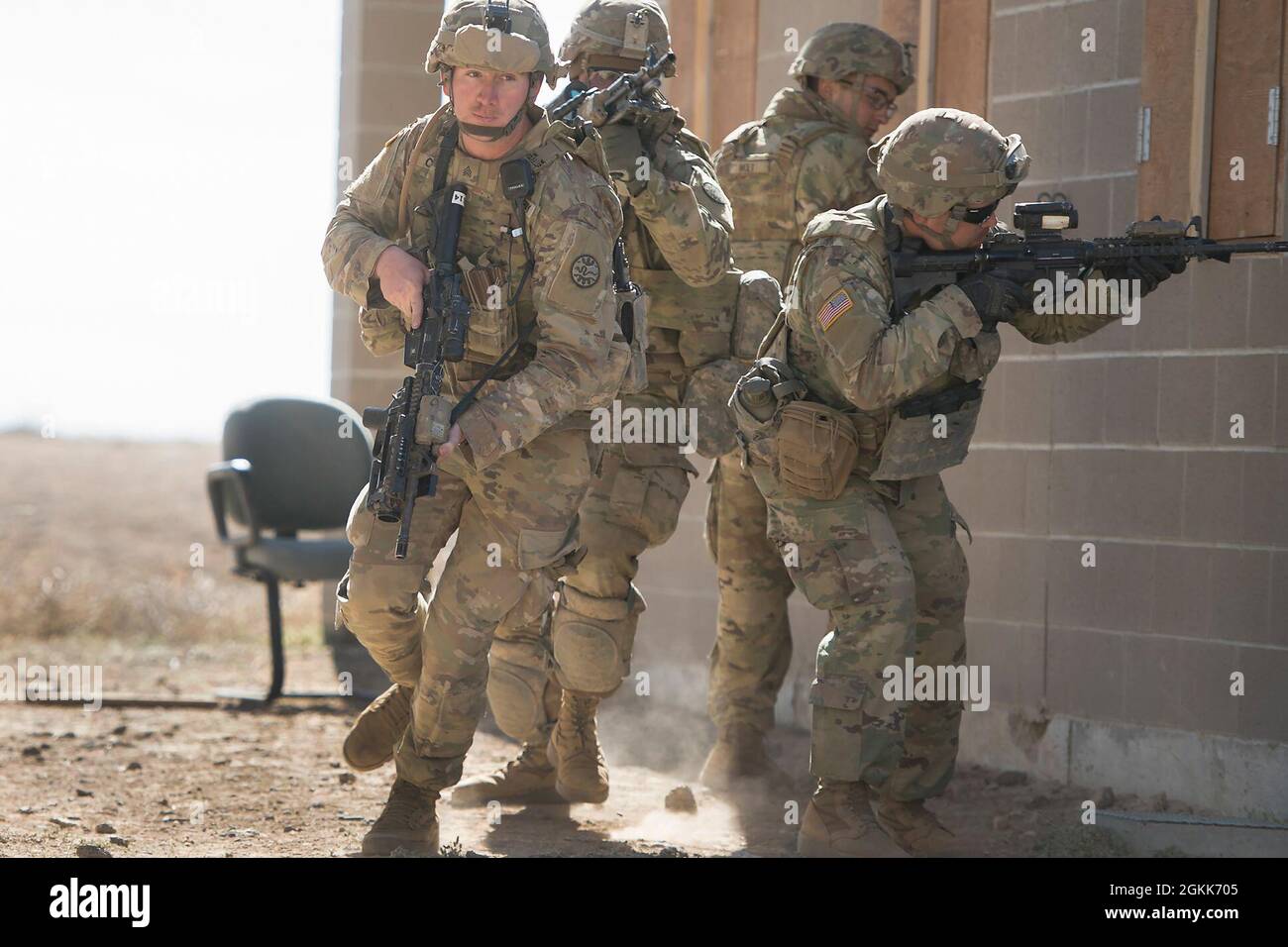 Soldiers from Charlie Company begin their run across the compound to ...