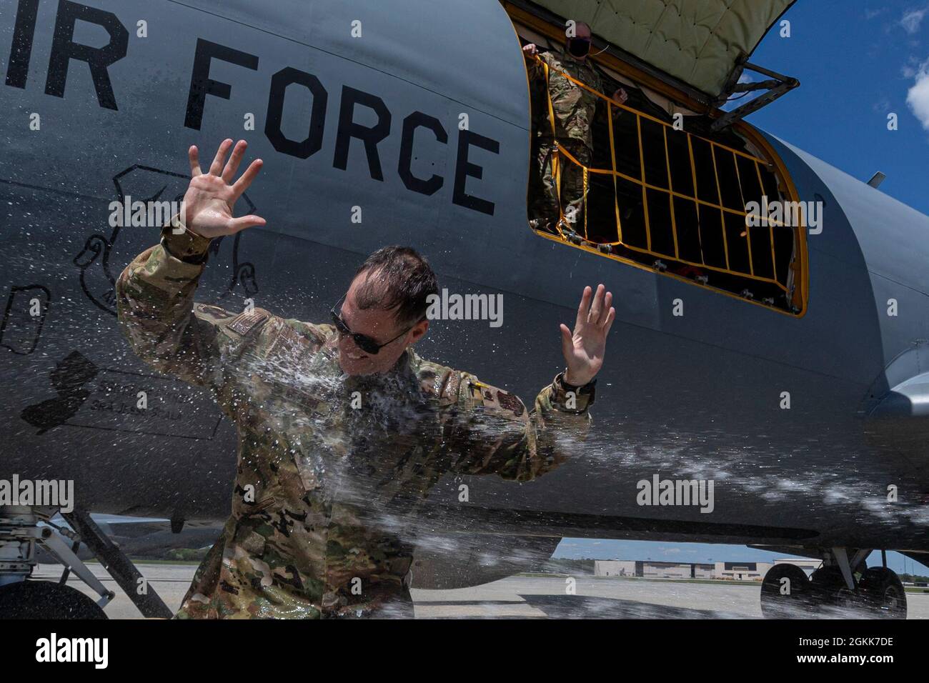 U.S. Air Force Lt. Col. Jason Miller is hosed down by his family after ...