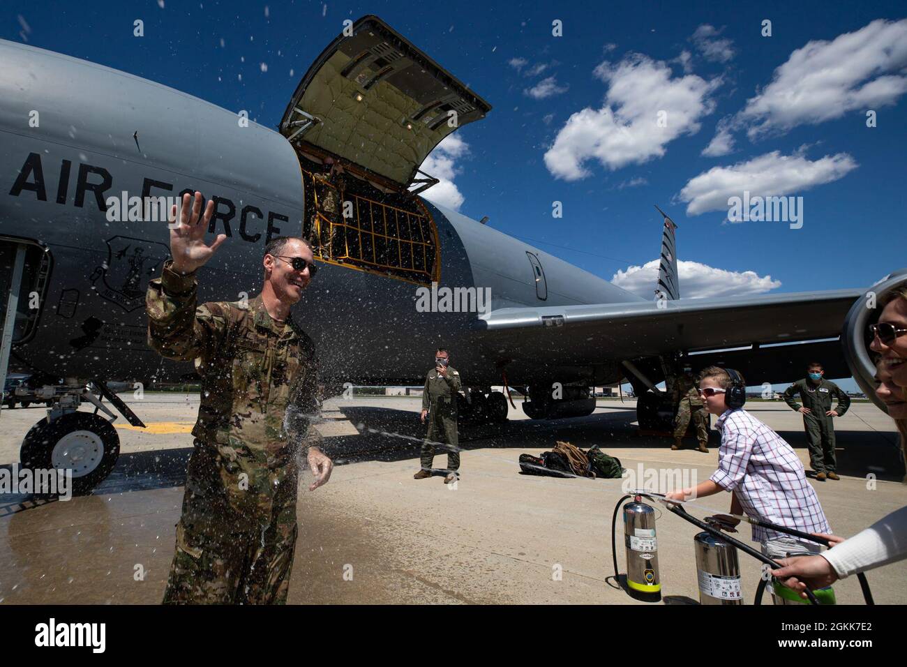 U.S. Air Force Lt. Col. Jason Miller is hosed down by his family after ...