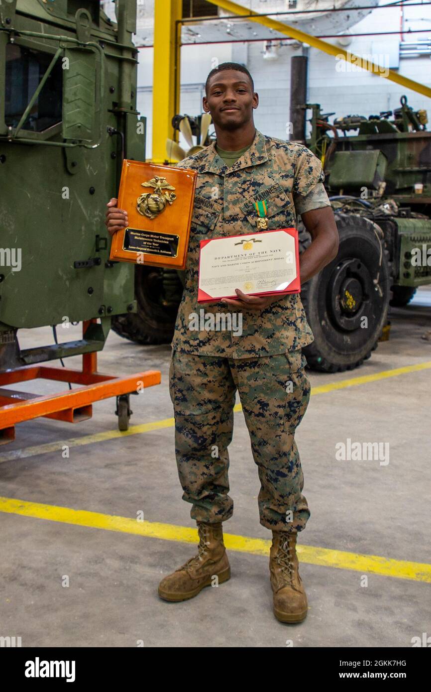 U.S. Marine Cpl. Kenneth L. Robinson, a motor vehicle technician, with ...