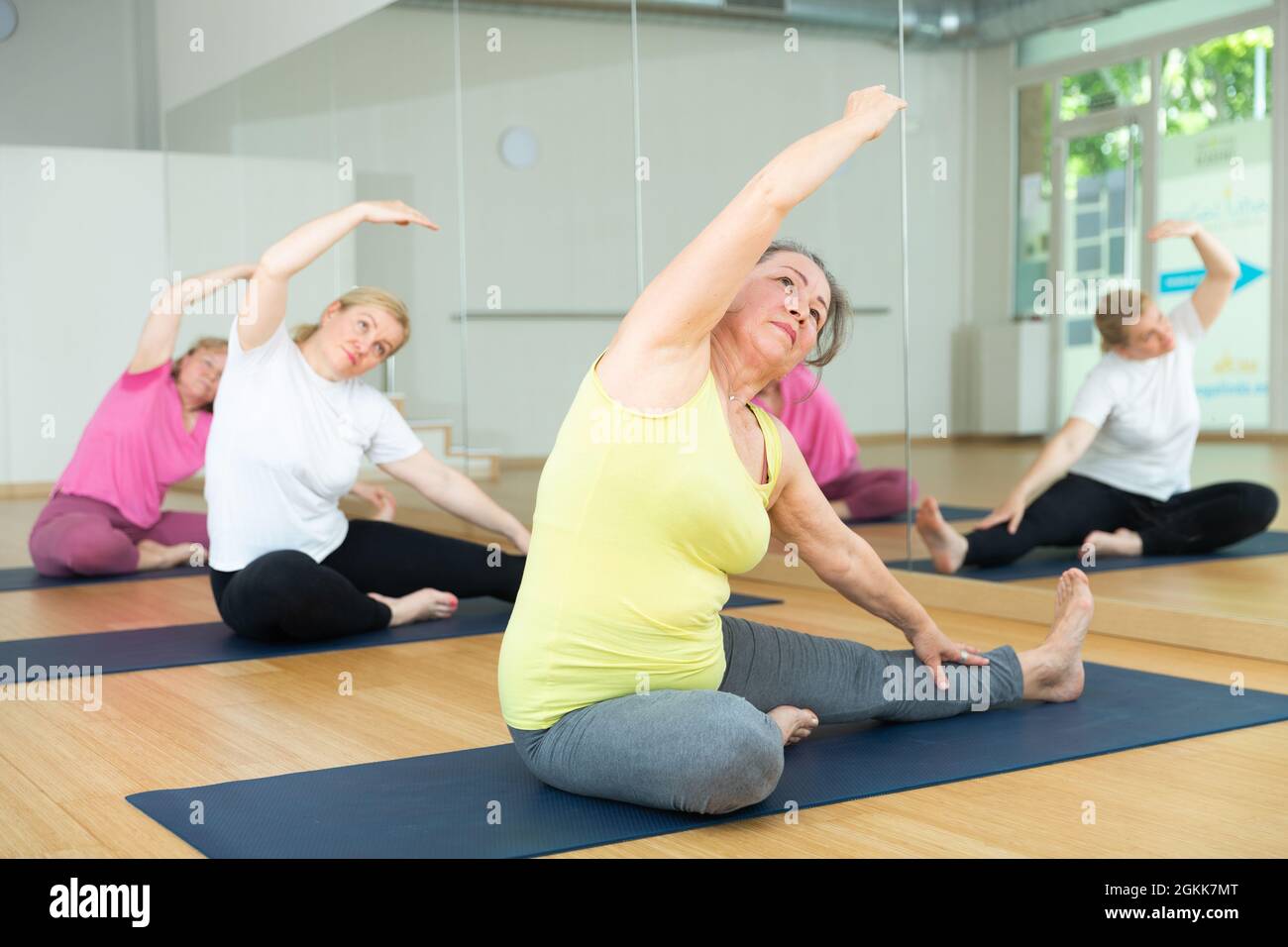 Women are doing one-legged forward bend Stock Photo - Alamy