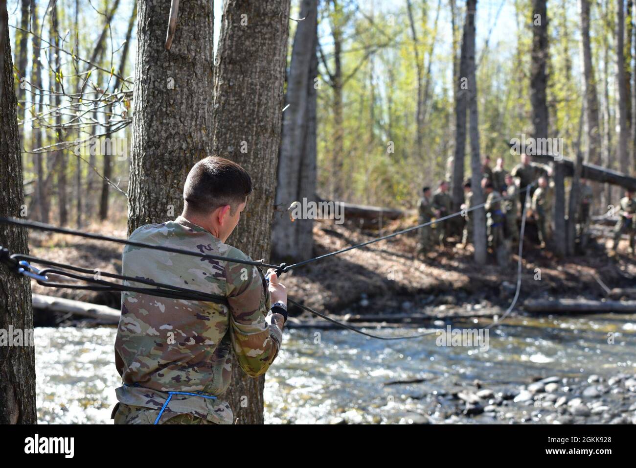 Sgt. 1st Class Randall Henrion loosens a knot to enable his platoon to ...