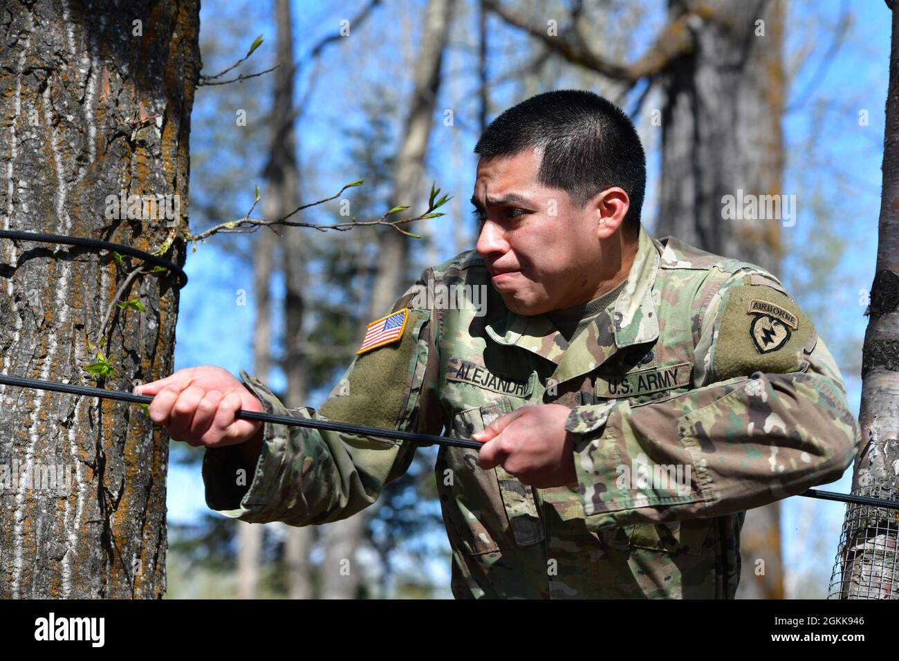 Spc. Jessy Alejandro Sanchez helps pull the rope taut to set up a one ...