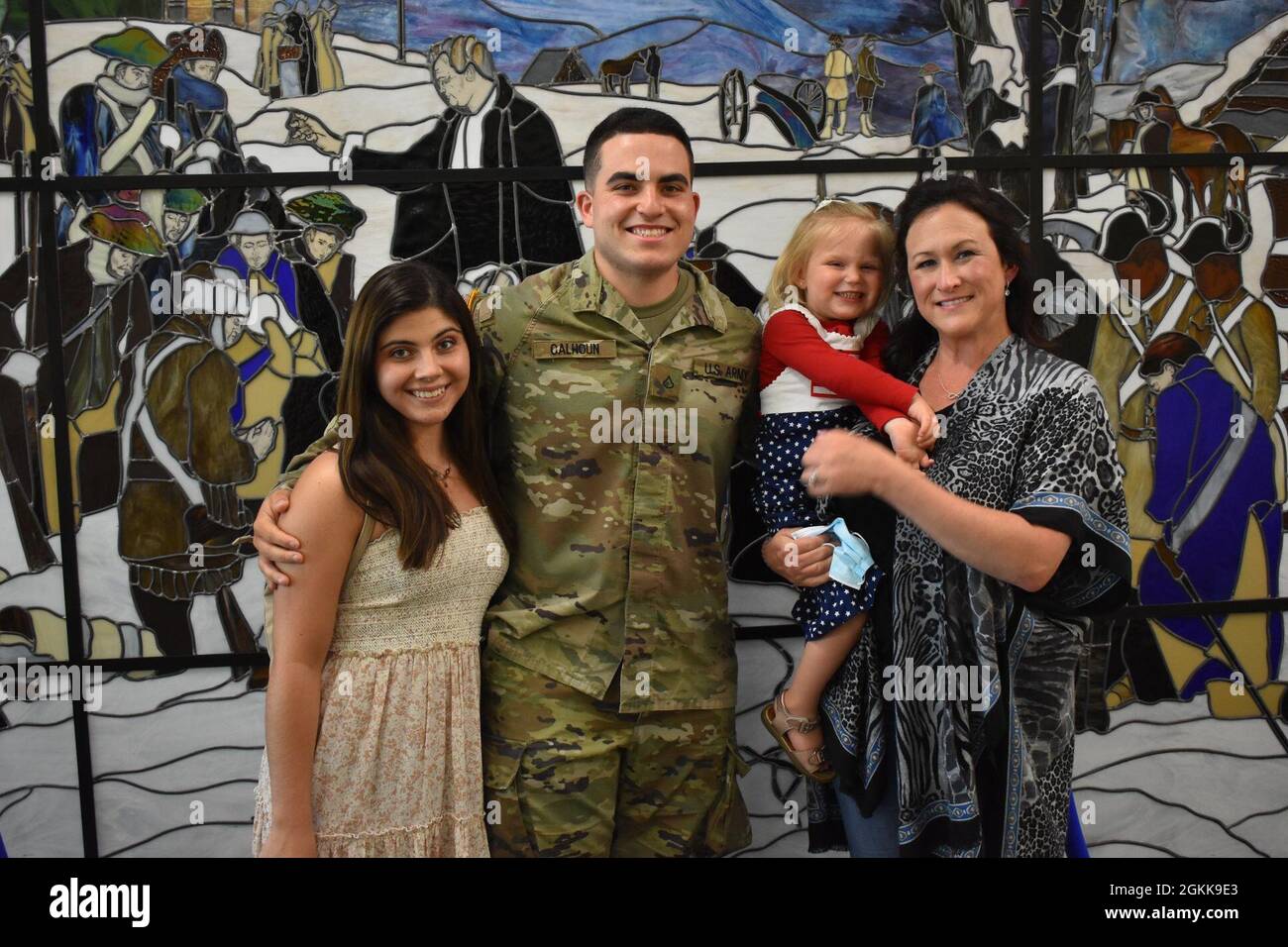 Pfc. Mason Calhoun, takes a photo with Family members after the ...