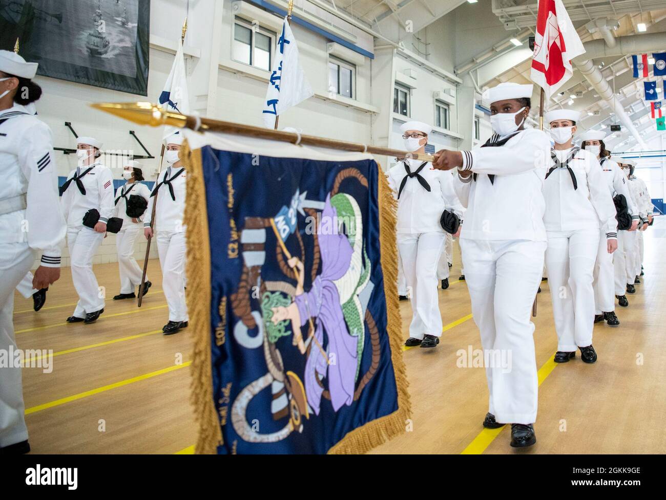 A recruit guideon renders a salute during a pass-in-review ceremony ...