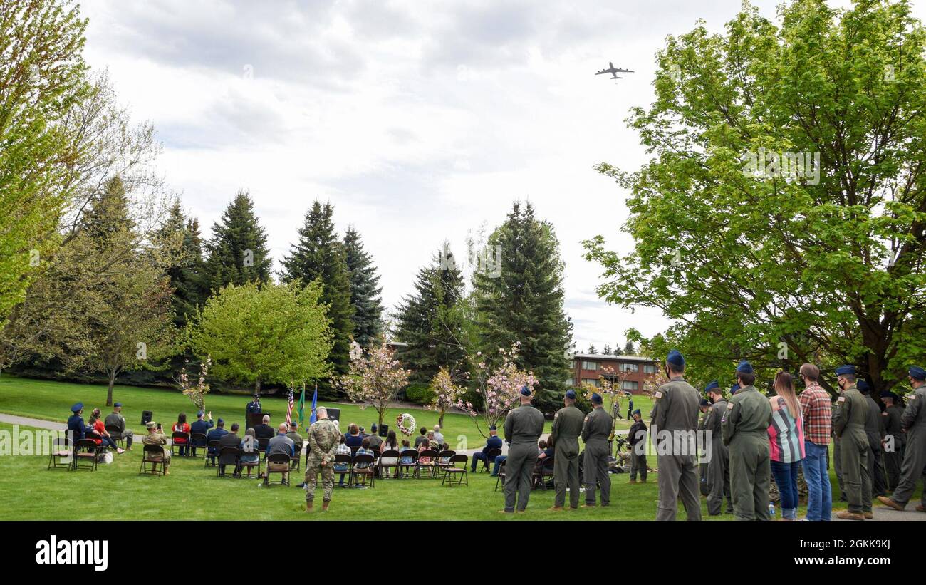 U.S. Air Force Airmen and family members watch as a flyover in honor of ...