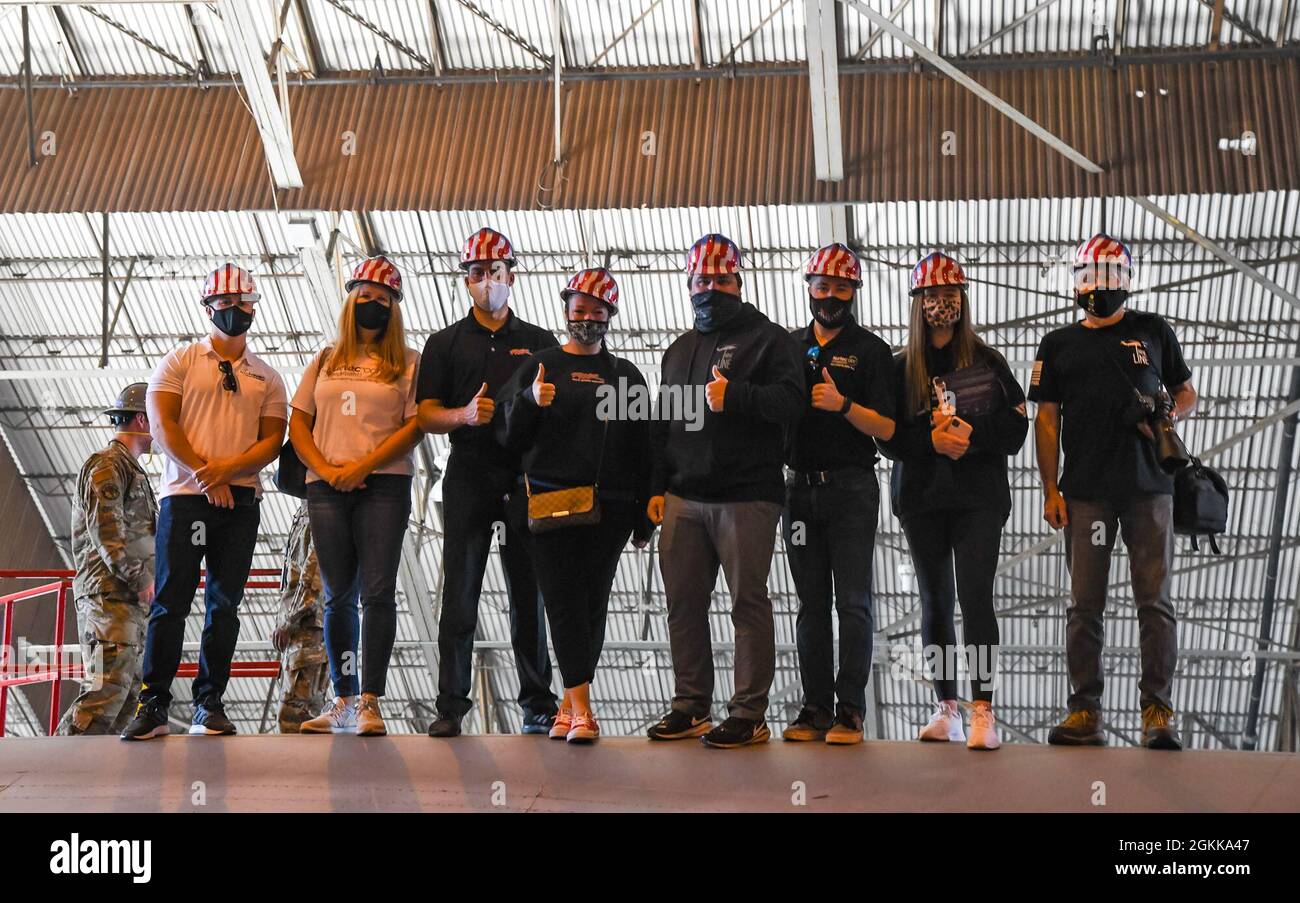 Garrett Smithley, NASCAR driver, and members of his team pose for a ...