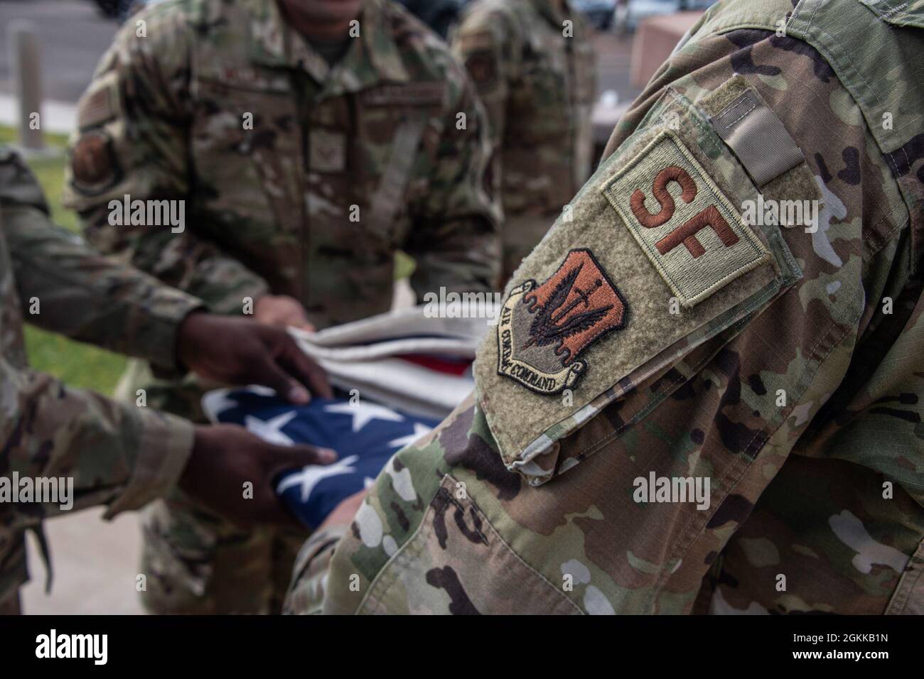 Defenders from the 355th Security Forces Squadron fold the flag during ...