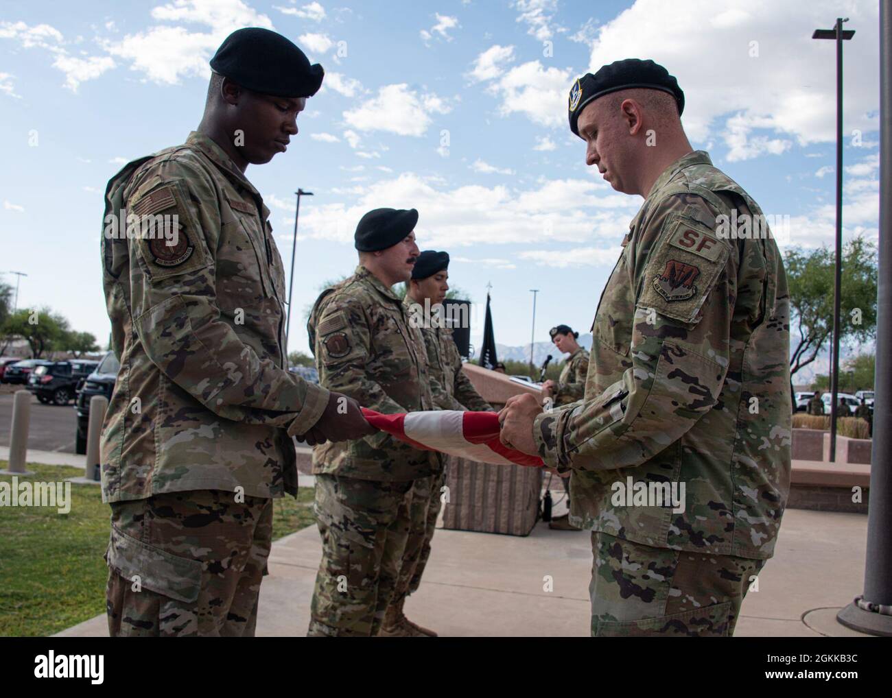 Defenders from the 355th Security Forces Squadron fold the flag during ...
