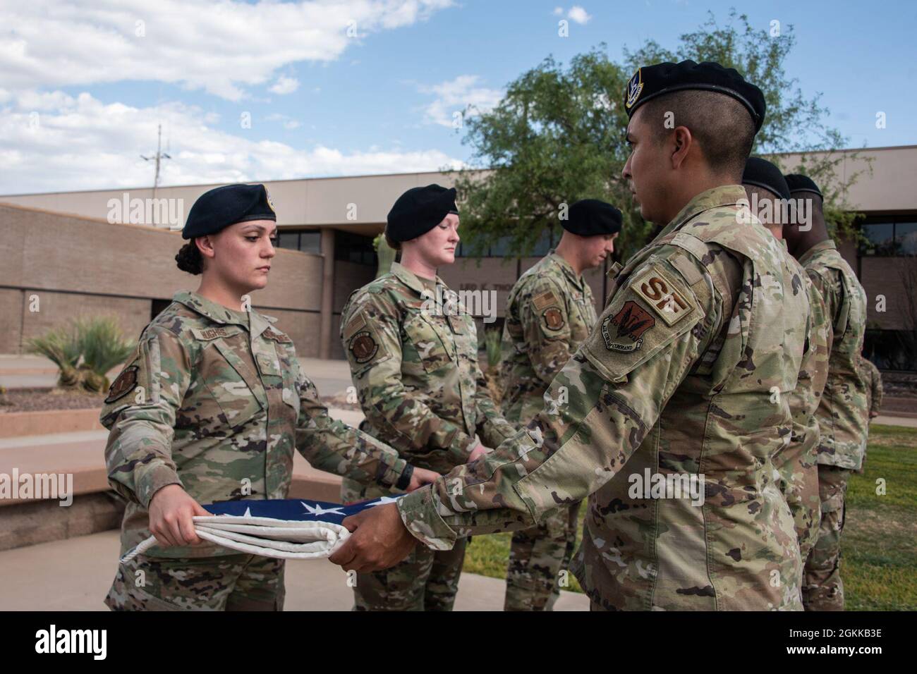 Defenders from the 355th Security Forces Squadron fold the flag during ...
