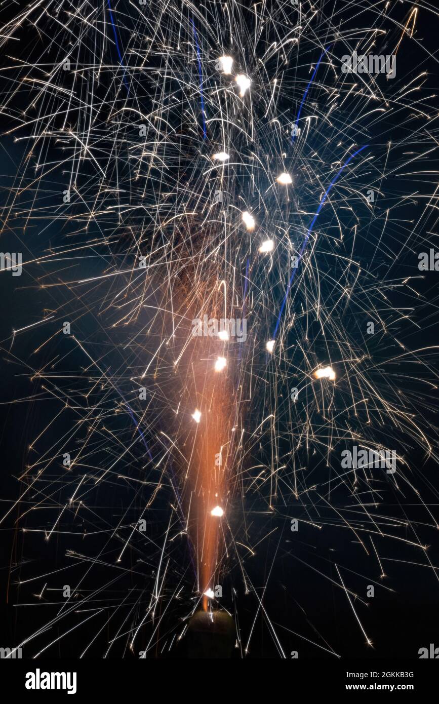 vertical of sparkler shooting firework sparks up into air Stock Photo ...