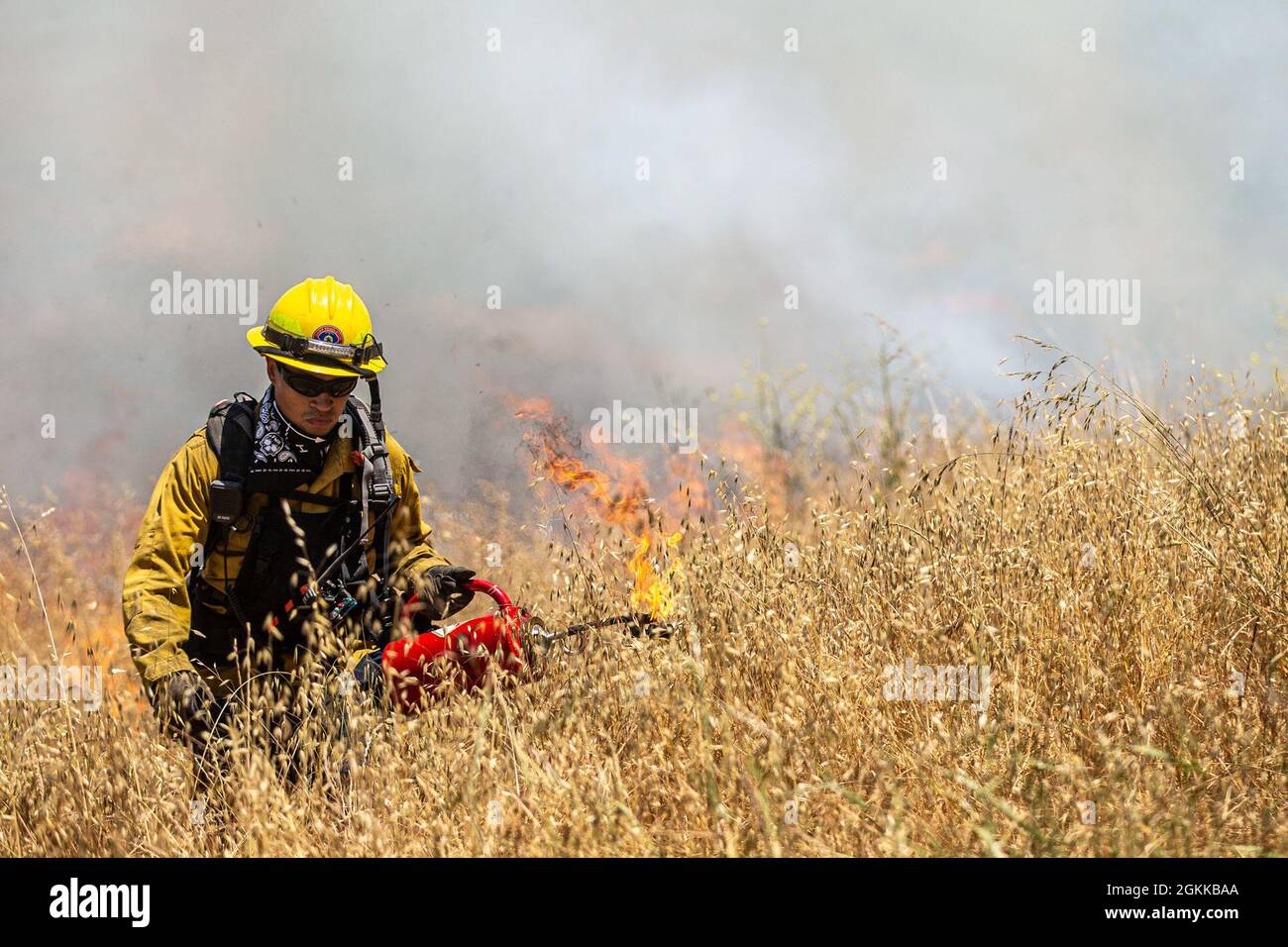 A firefighter with the Camp Pendleton Fire Department ignites dry ...