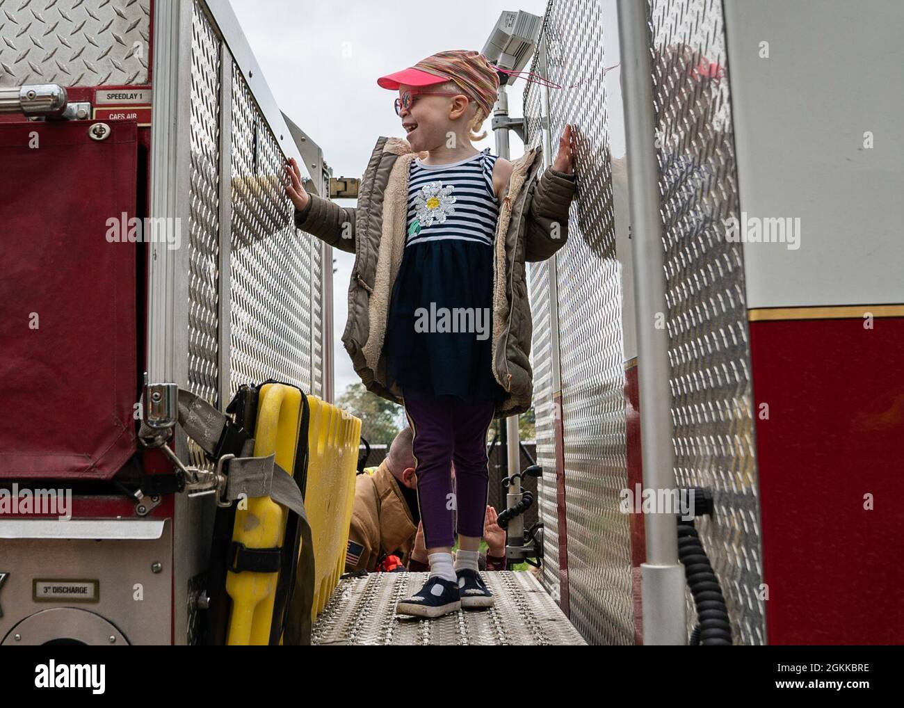 A Liberty Wing child walks along the back of a 48th Civil Engineering ...