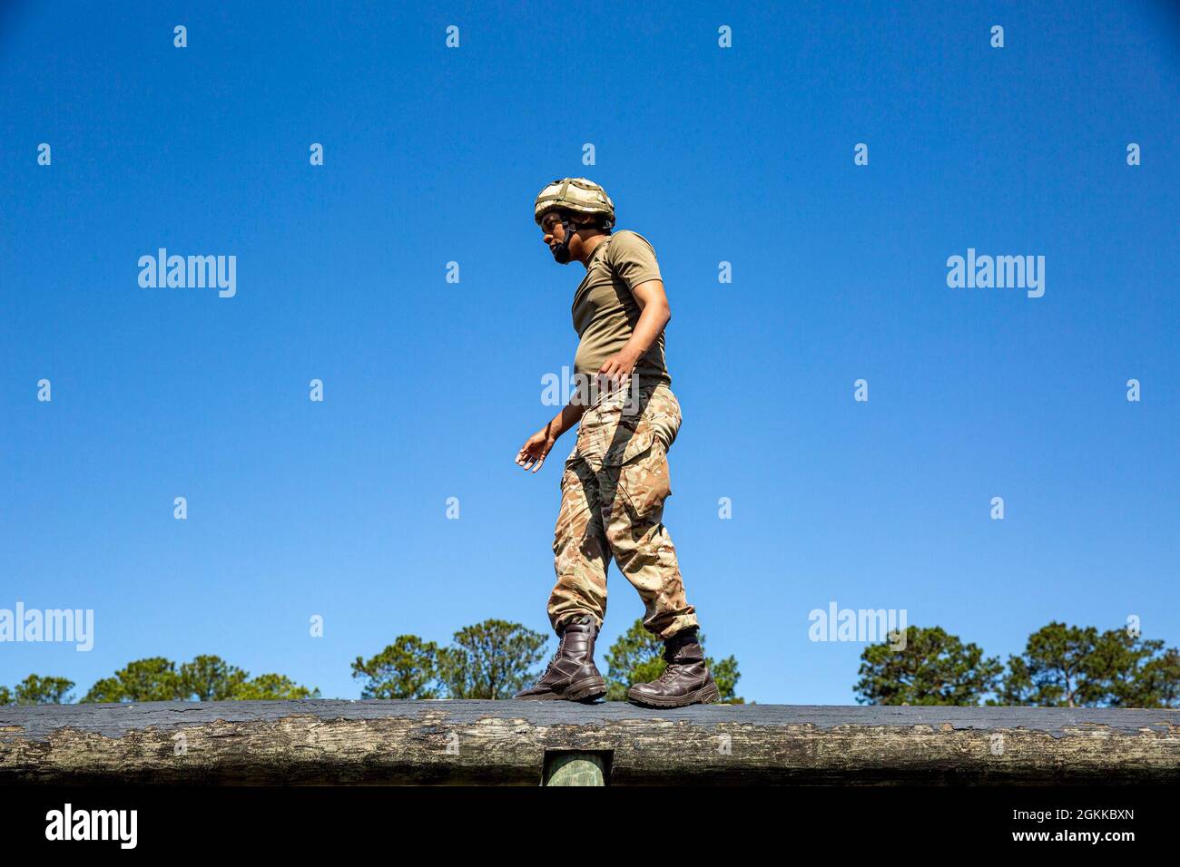Royal Bermuda Soldier Pvt. Brian Philip walks across an obstacle in the ...