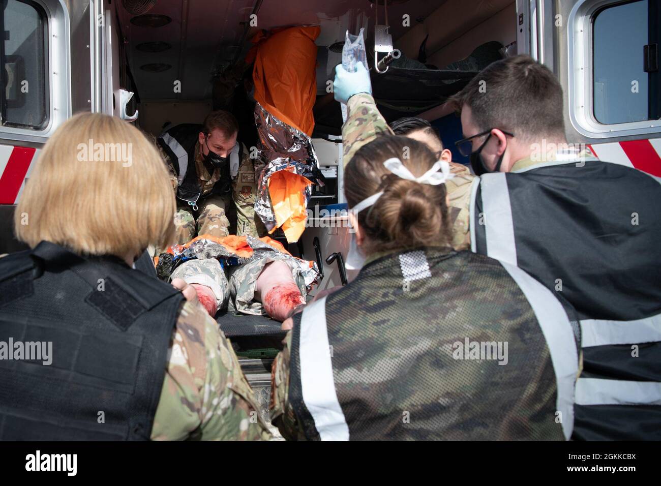 Members of the 28th Medical Group load a simulated injured patient into ...