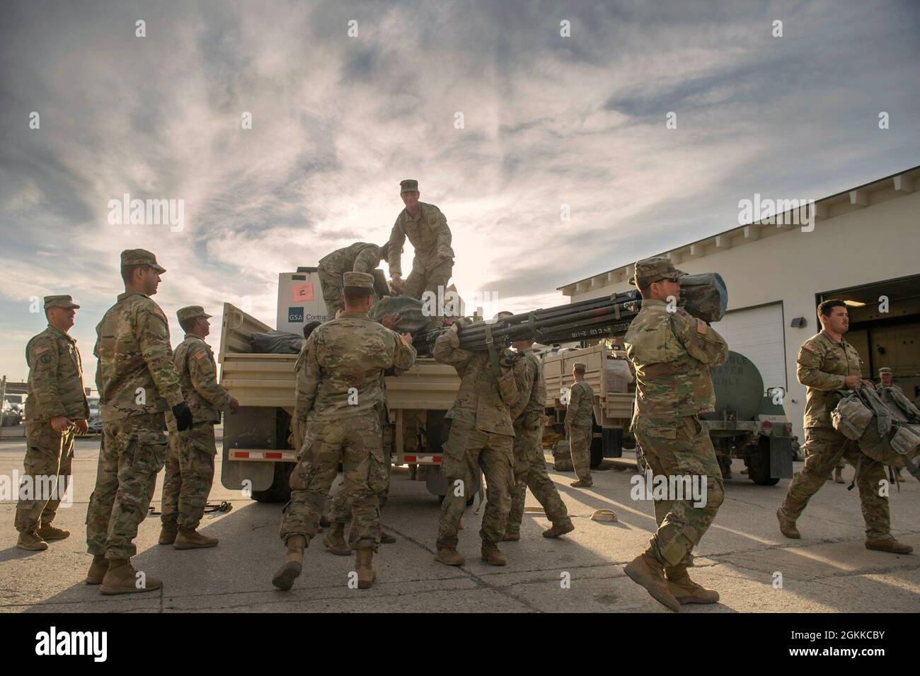 Soldiers from Charlie Company help unload vehicles in the company ...