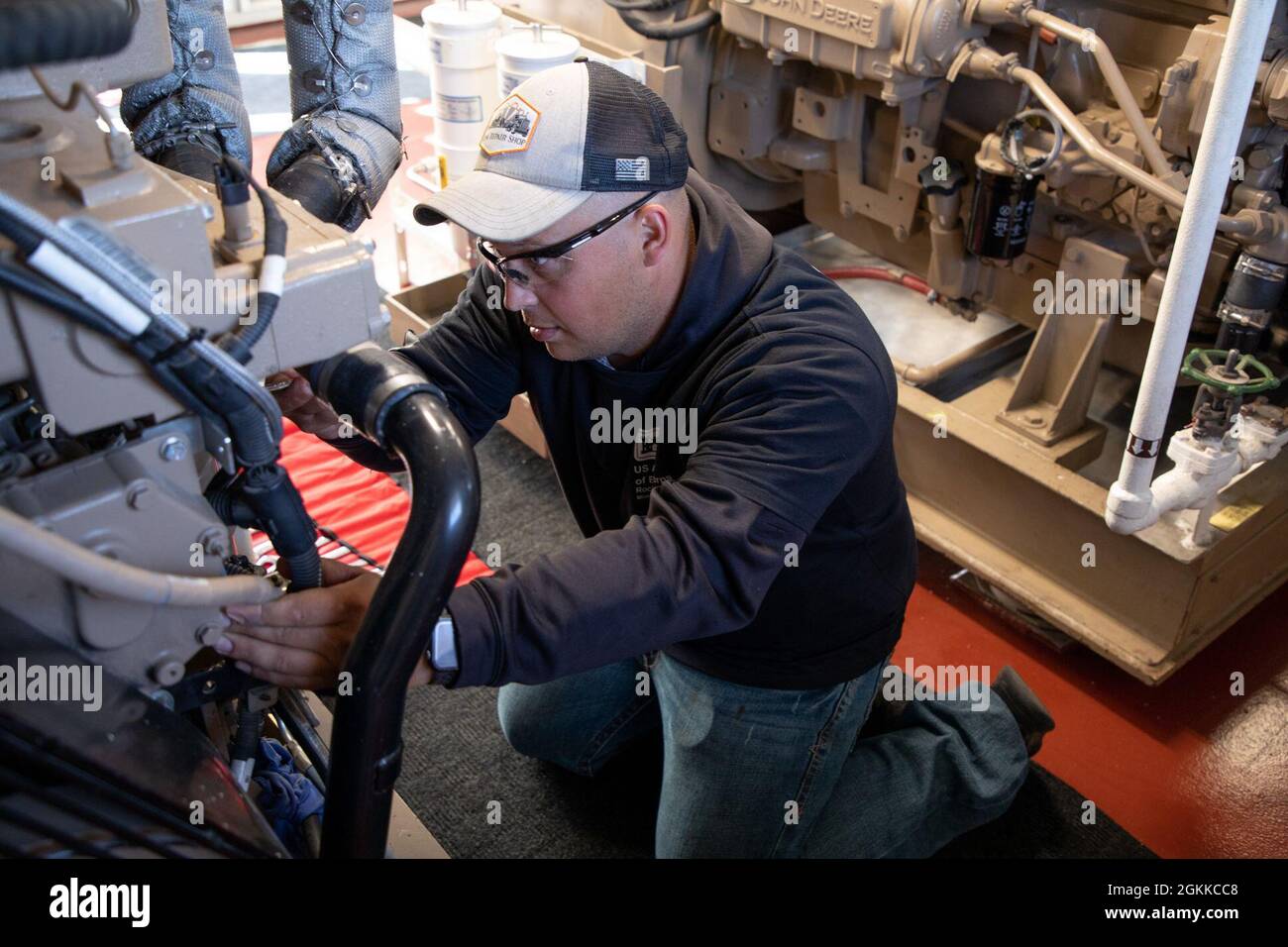 Engineer Tony Frost kneels as he works on a generator aboard the Quad ...