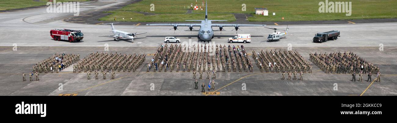 Aircraft and members from the 374th Airlift Wing stand together for a ...