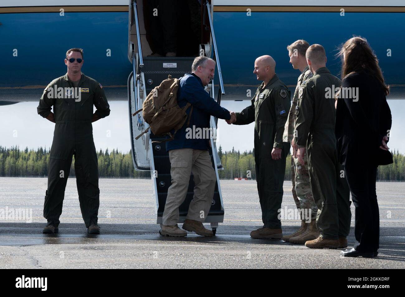 U.S. Sen. Dan Sullivan shakes hands with Col. David Berkland, the 354th ...