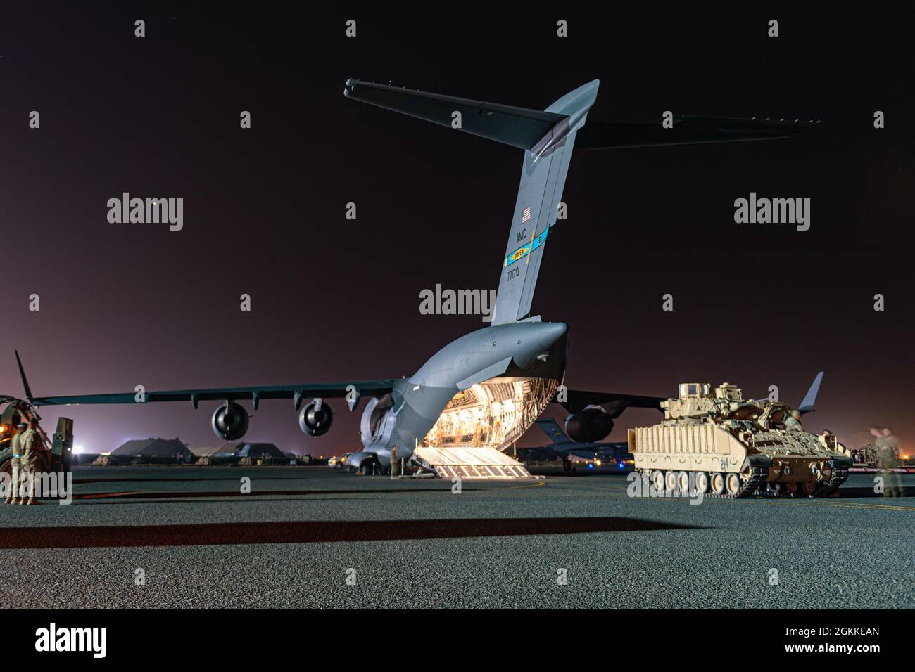 U.S. Airmen load a C-17 Globemaster III at Ali Al Salem Air Base ...
