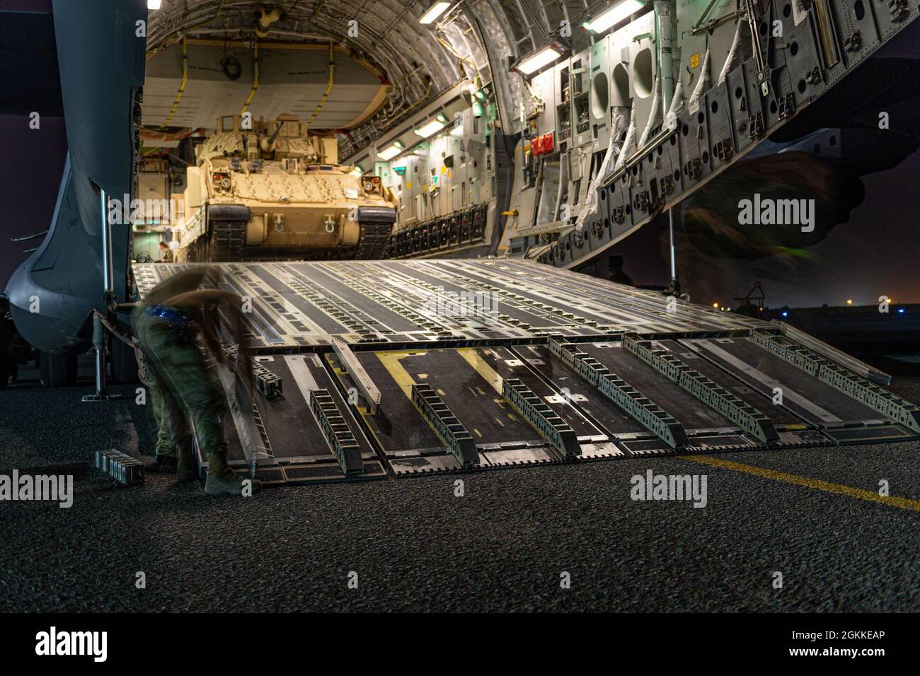 U.S. Airmen load a C-17 Globemaster III at Ali Al Salem Air Base ...