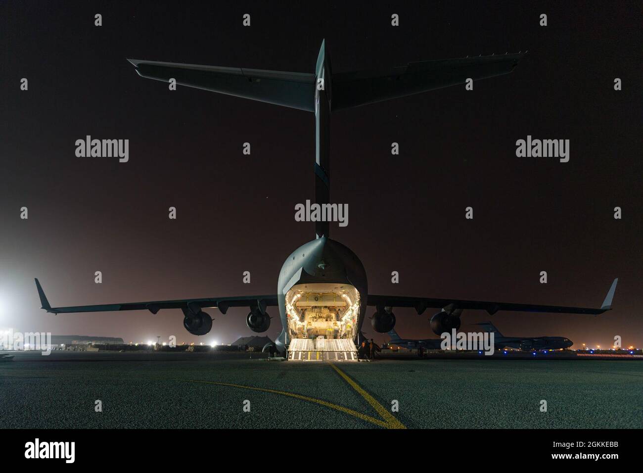 U.S. Airmen load a C-17 Globemaster III at Ali Al Salem Air Base ...