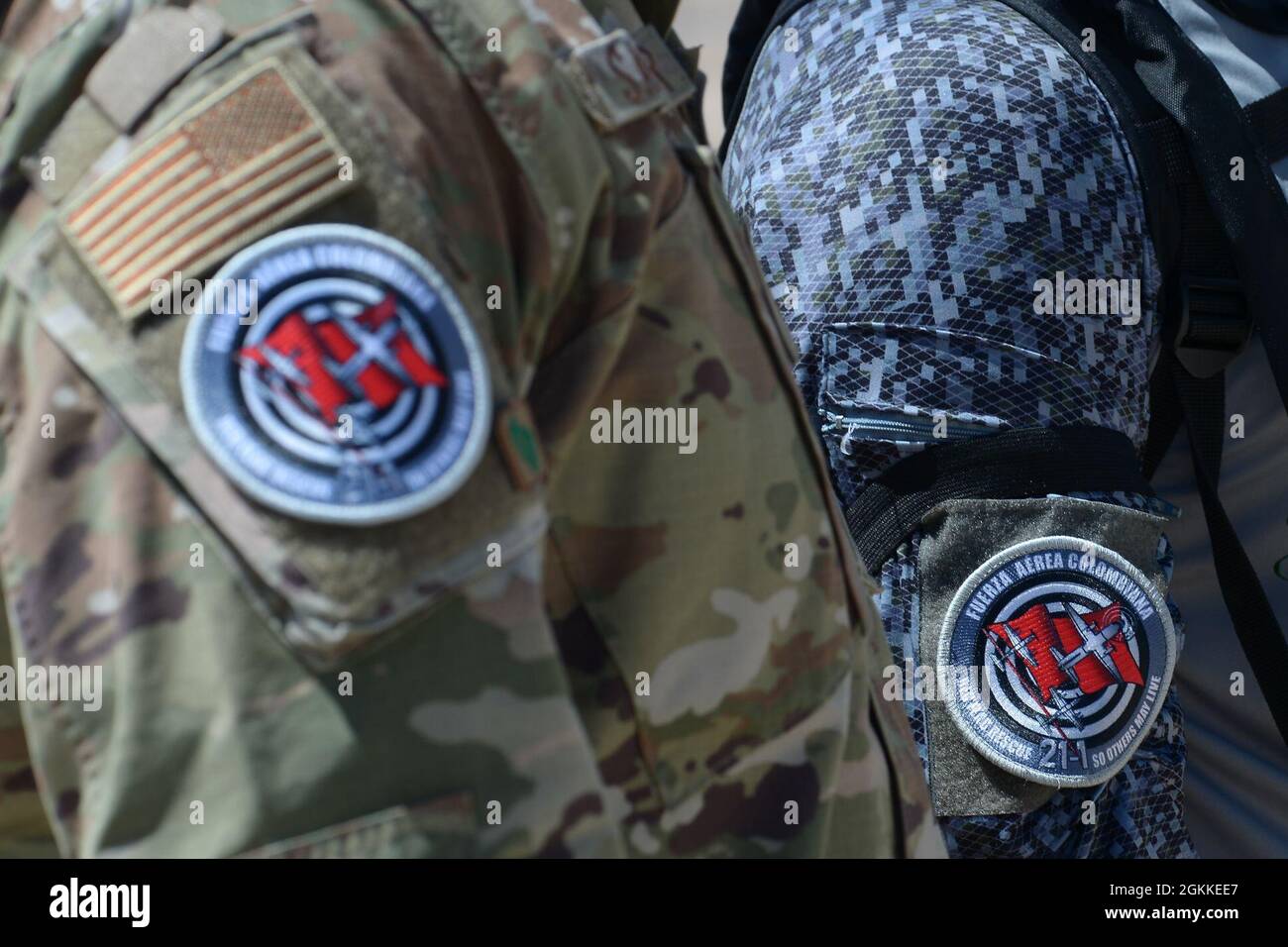 A United States Air Force Airmen and Colombian Air Force Airmen stand ...